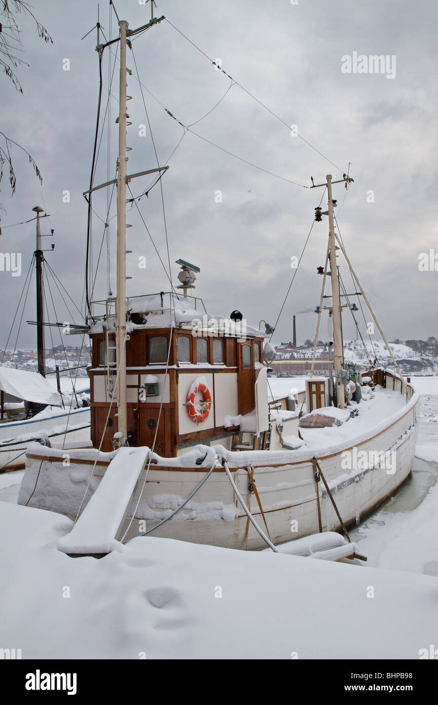 Old fishing boat covered in snow in winter Stock Photo - Alamy