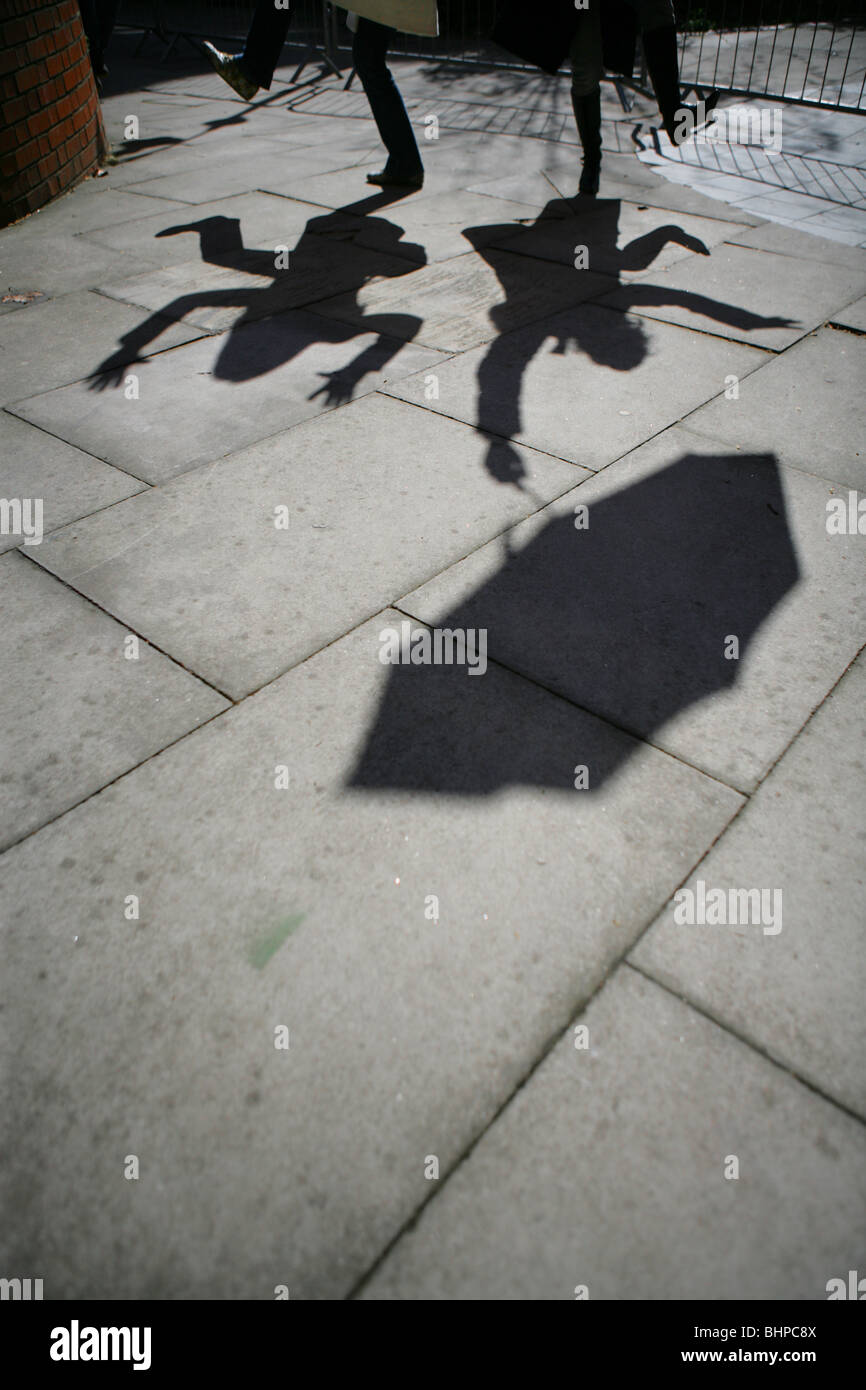 Image focusing on the shadows of two women standing on one leg with ...