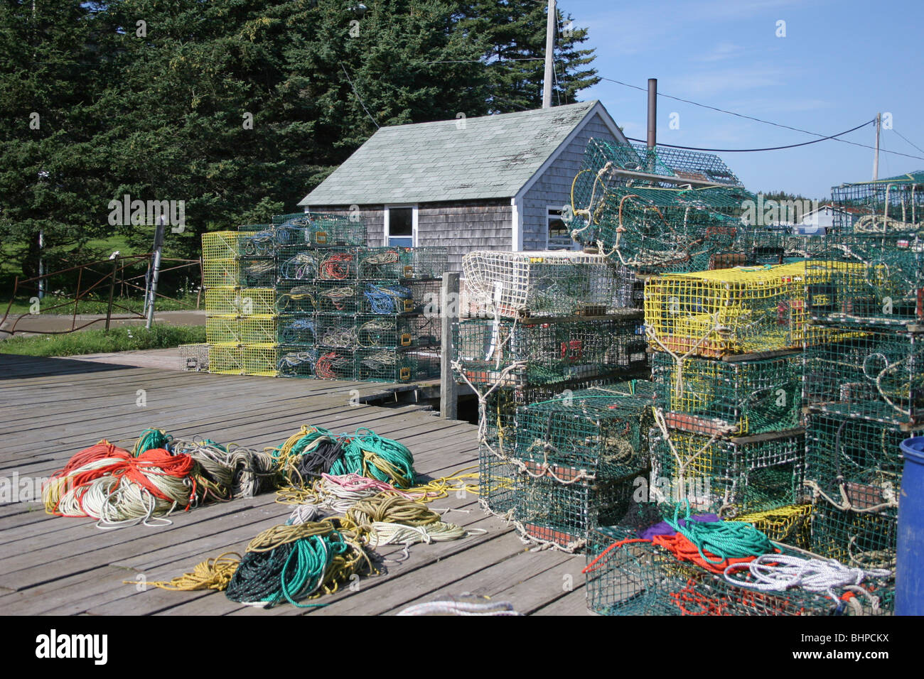 Lobster Traps and colorful pot lines lie about on a pier at Port Clyde ...