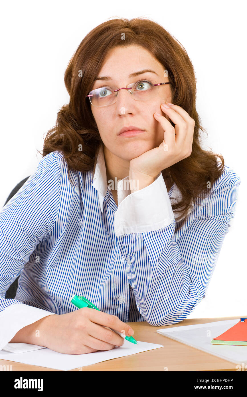 Smiling young business woman writing on a desk, isolated on white ...