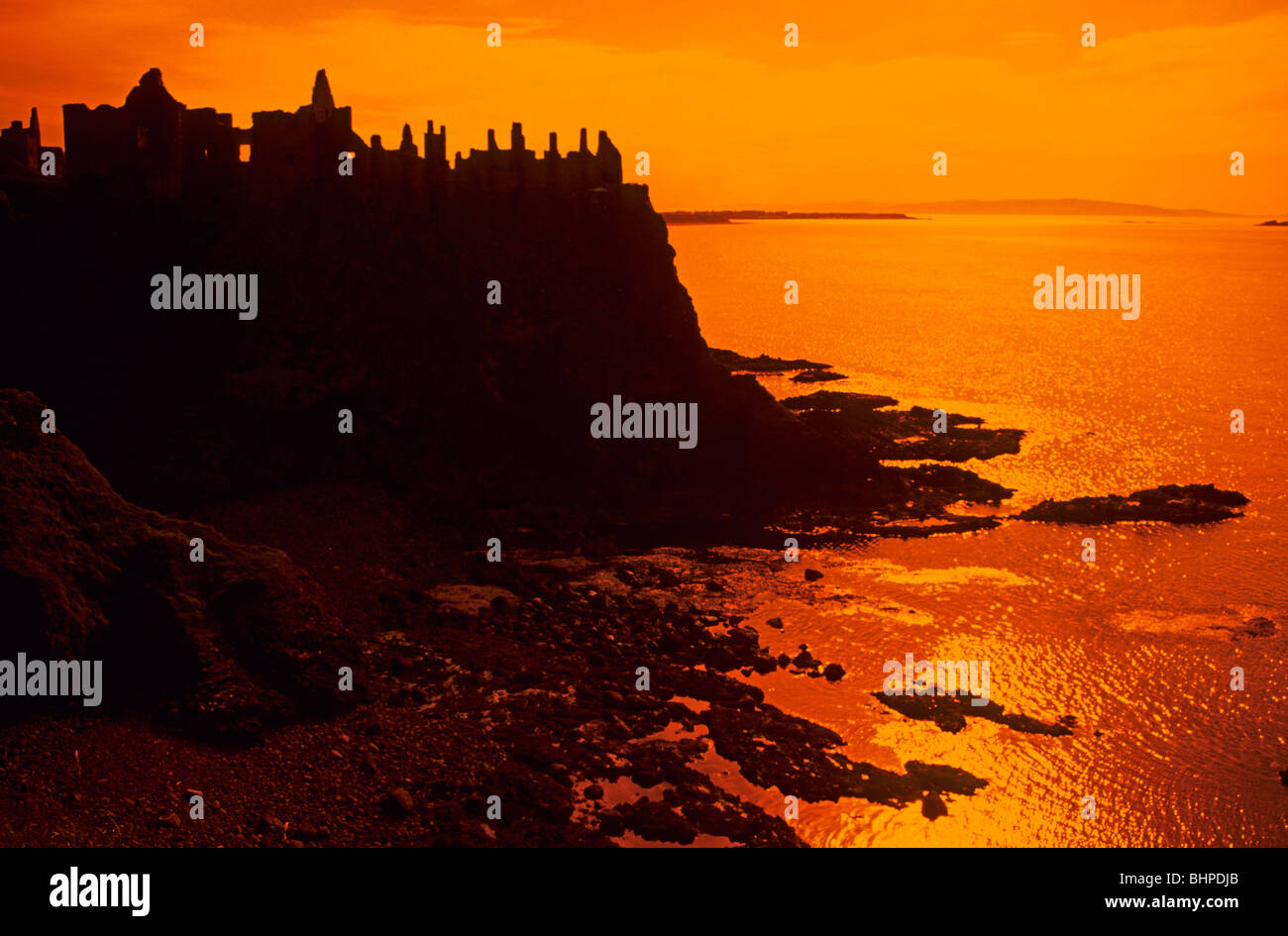 Silhouette of Dunluce Castle at sunset, Co. Antrim, Northern Ireland ...
