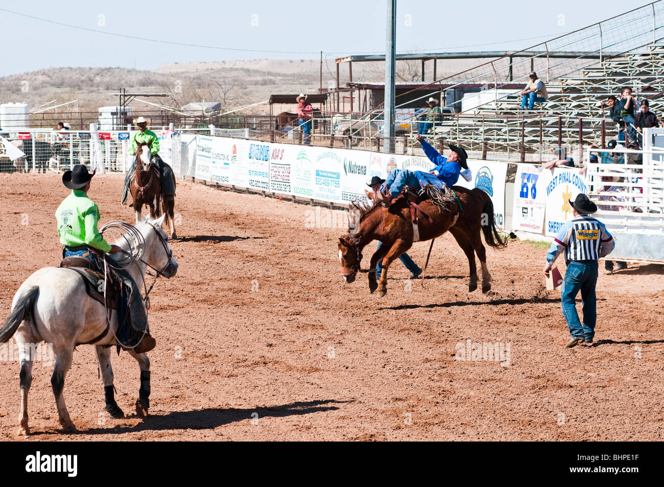a cowboy competes in the saddle bronc riding event during the O'Odham ...