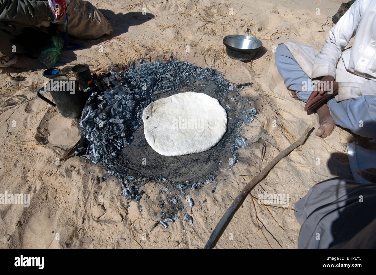 Bedouin men prepare the Libeh, a Bedouin version of simple unleavened ...