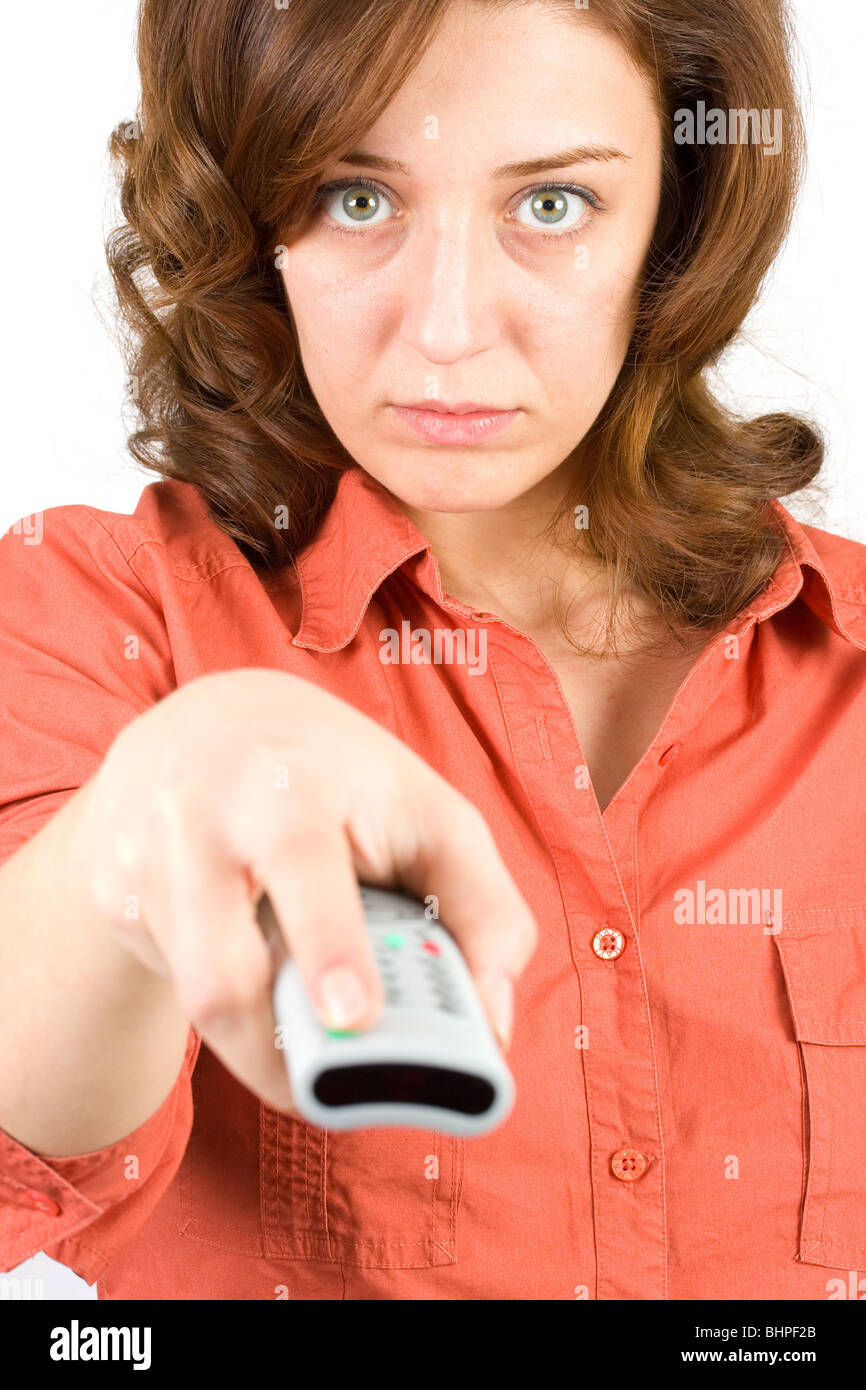 Portrait of a young woman using tv remote control isolated on white ...
