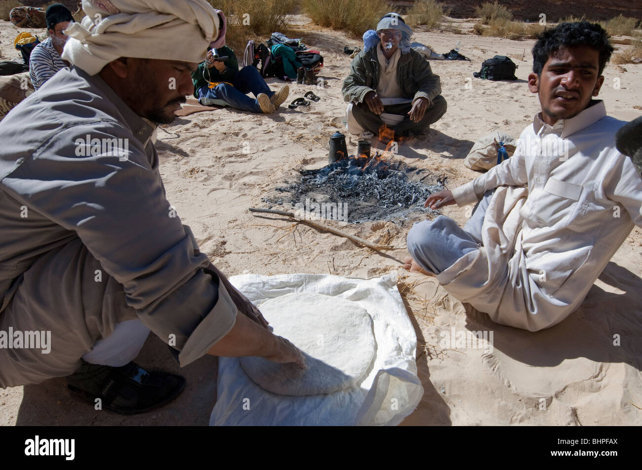 Bedouin men prepare the Libeh, a Bedouin version of simple unleavened ...