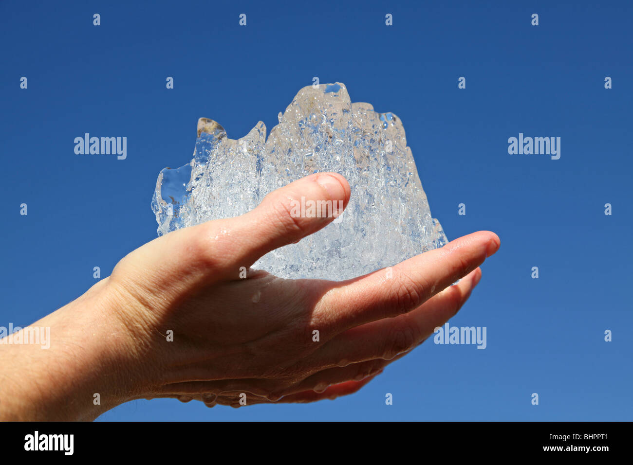 Hand holding piece of ice Stock Photo - Alamy