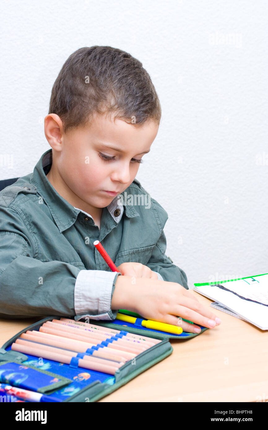 Portrait of a cute schoolboy drawing Stock Photo - Alamy
