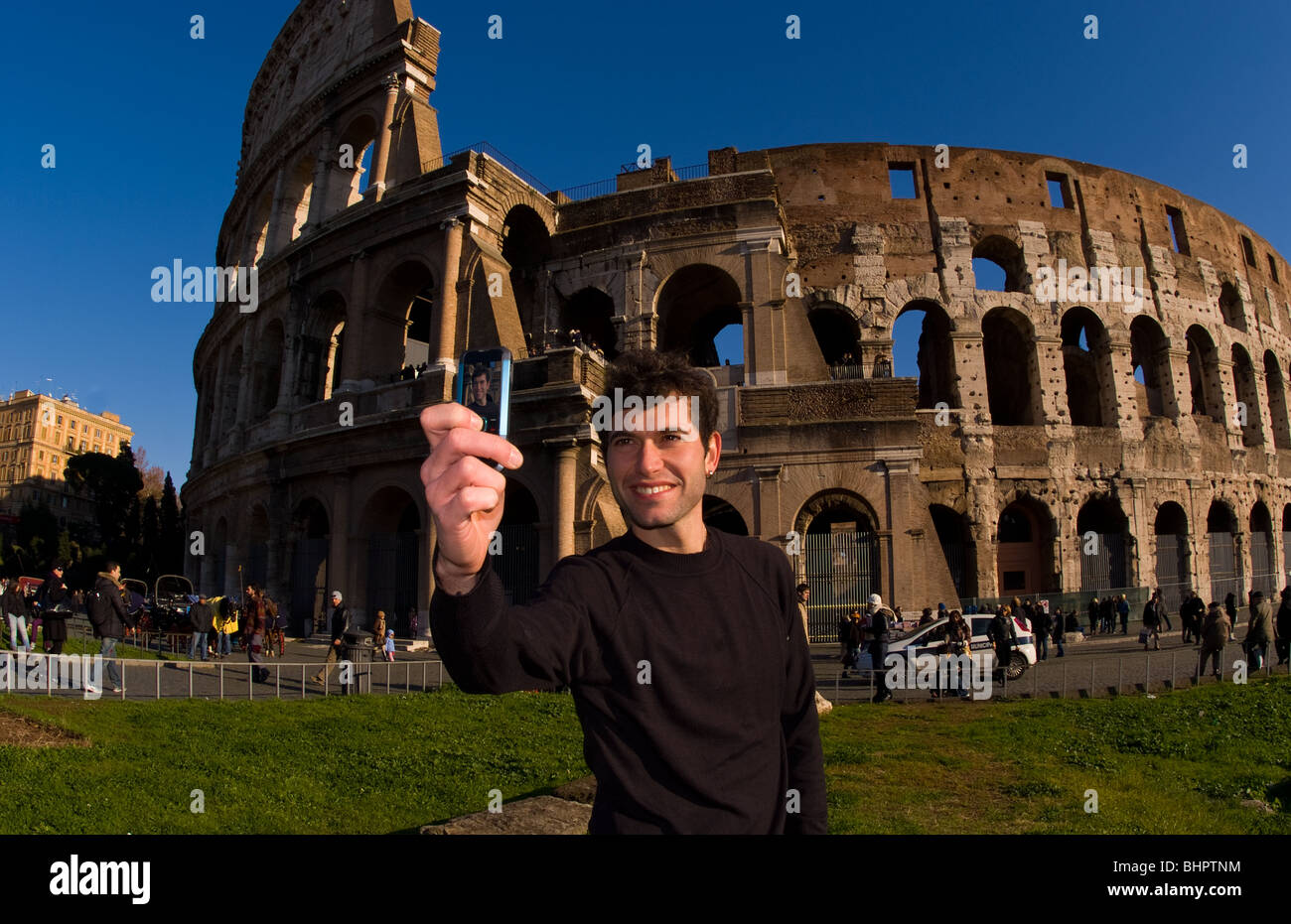 Local Italian man taking photo at famous Colosseum in Rome Italy ...