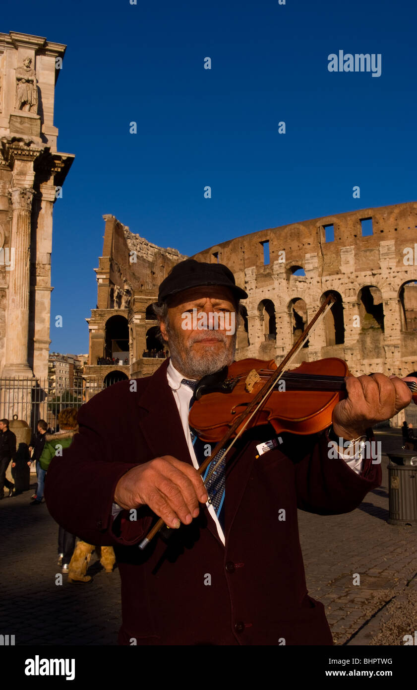 Local man playing violin at famous Colosseum in Rome Italy Landmark ...