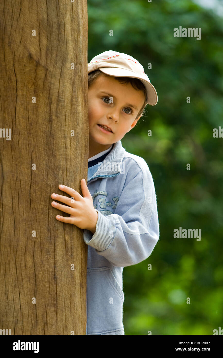 Pretty little boy hiding Stock Photo - Alamy