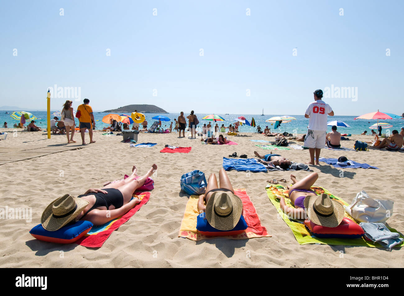 Three young lady's laying on the beach taking a sunbath on a sunny ...