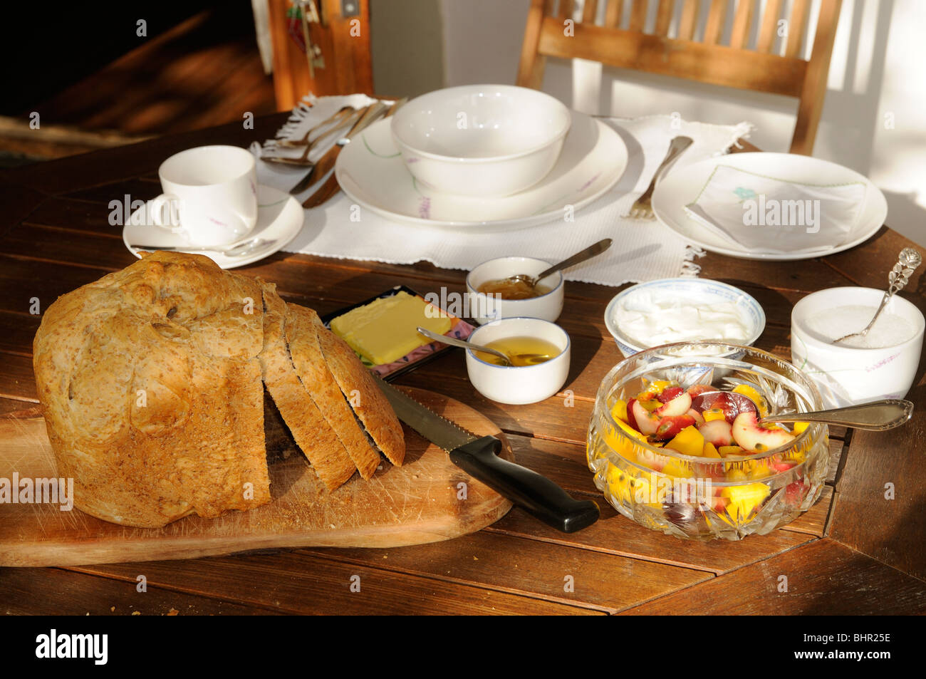 freshly baked loaf of bread on breakfast table Stock Photo - Alamy