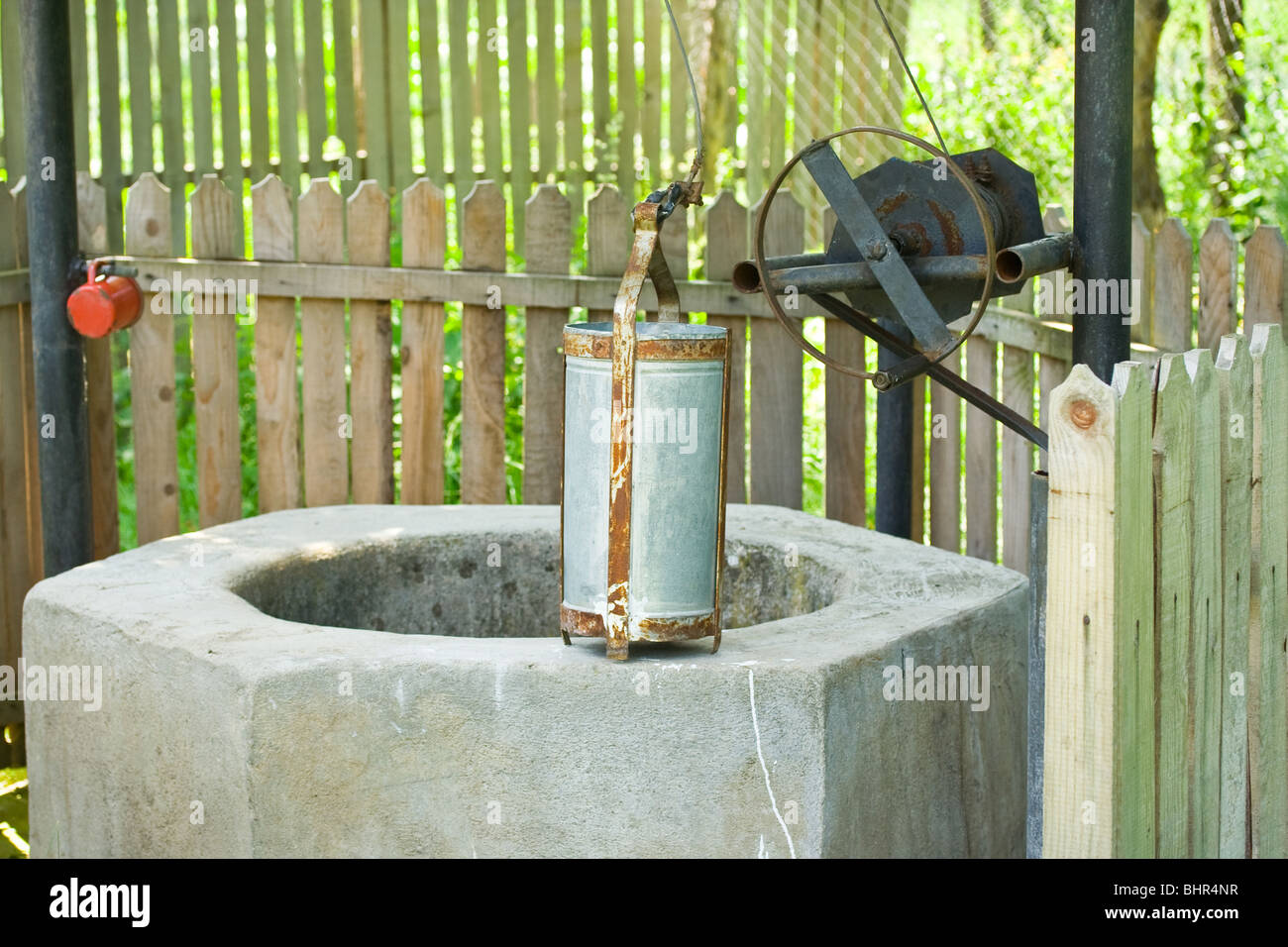 Old well with a metal bucket Stock Photo - Alamy