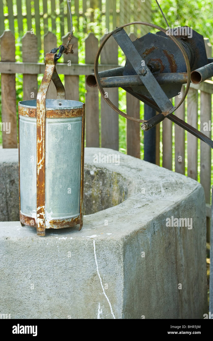 Old well with a metal bucket Stock Photo - Alamy