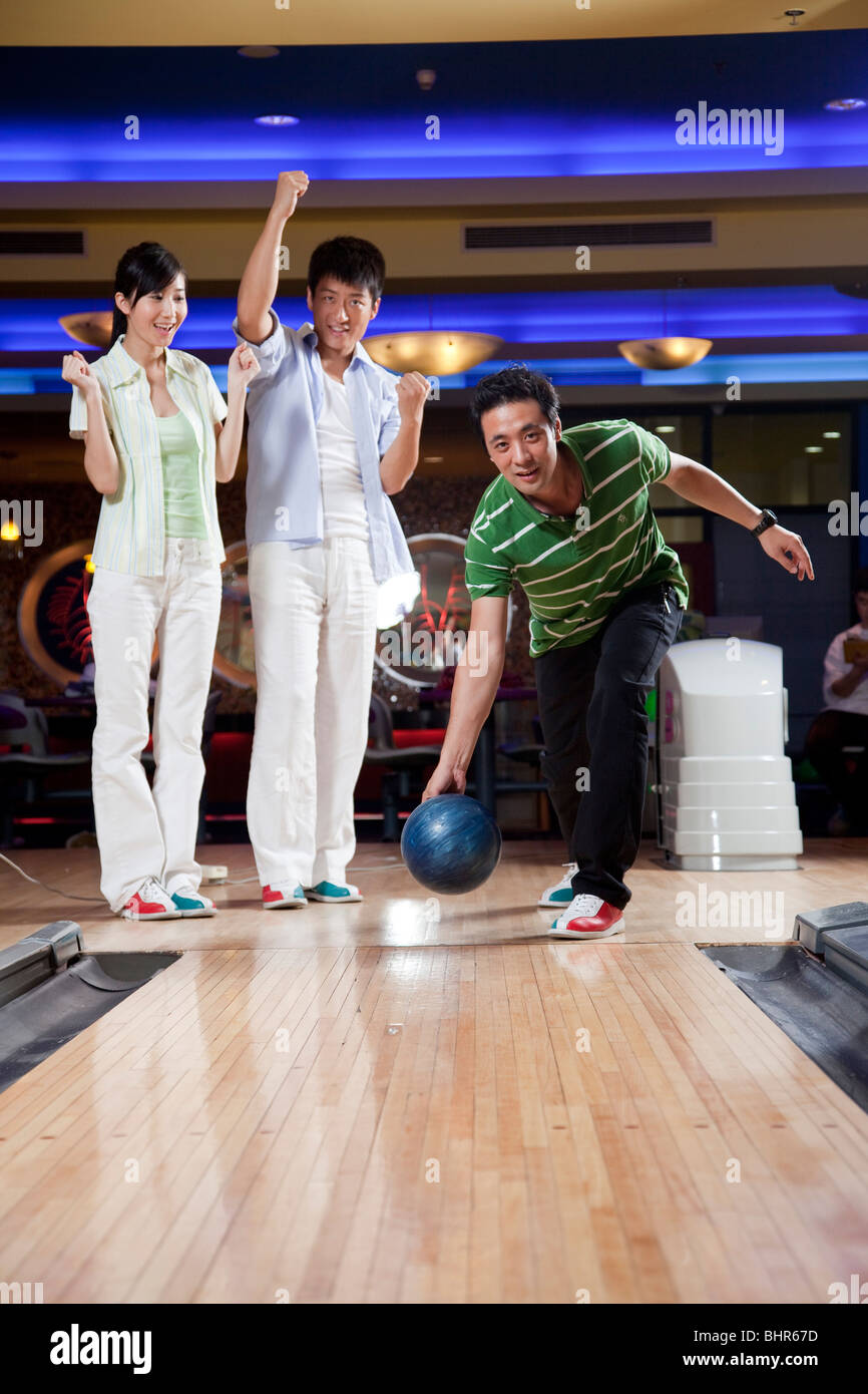 Three young women bowling hi-res stock photography and images - Alamy