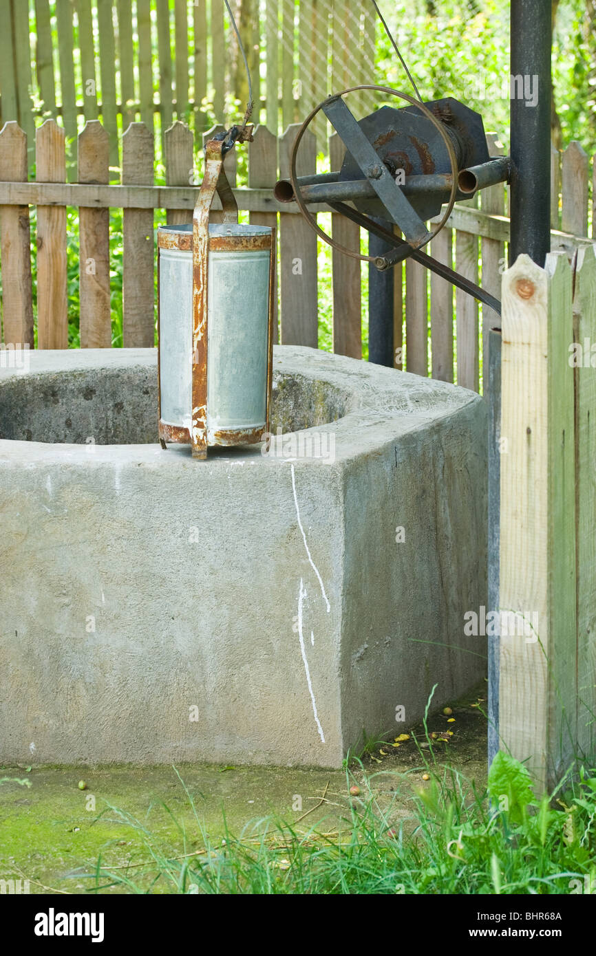 Old well with a metal bucket Stock Photo - Alamy