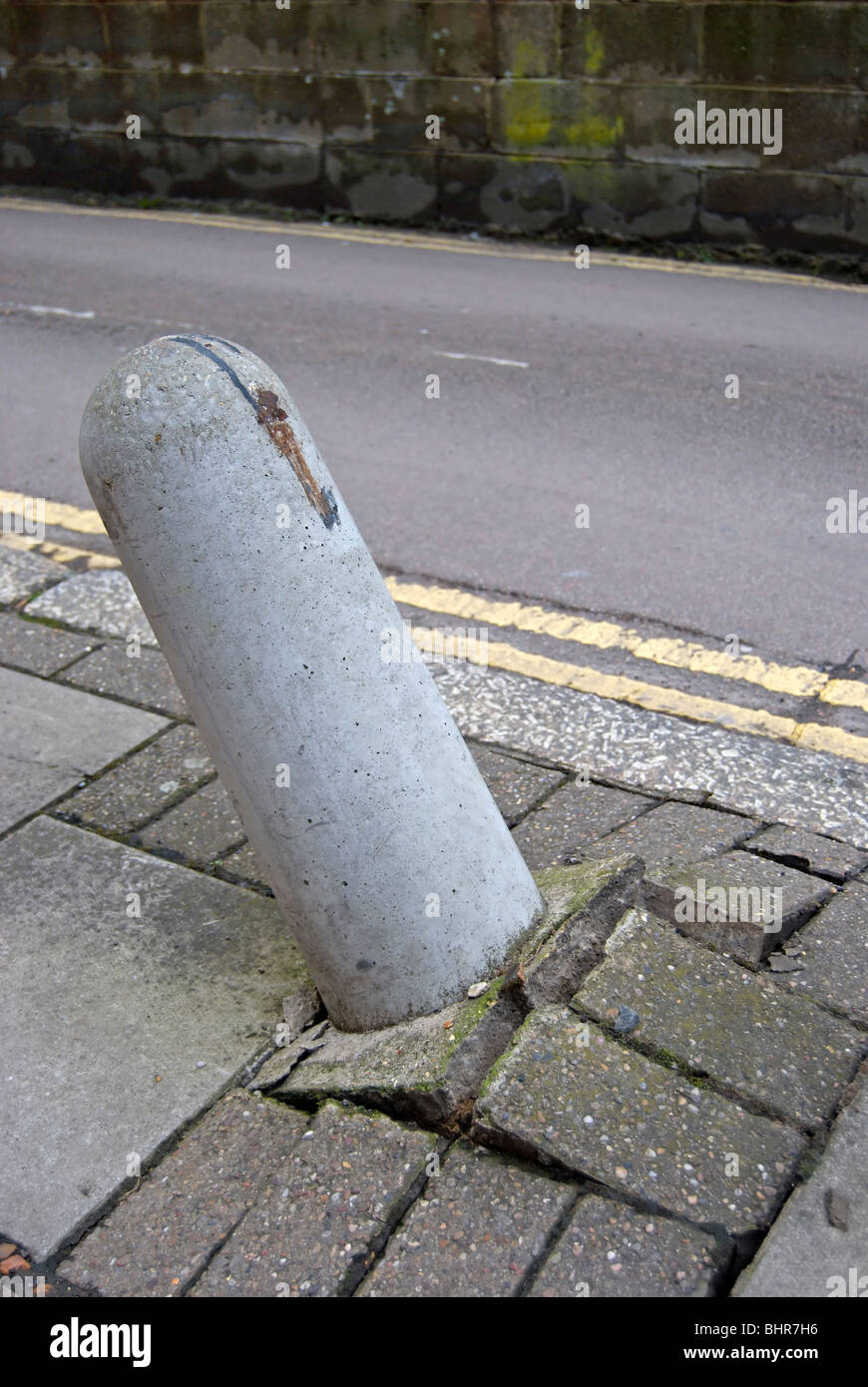 leaning british traffic bollard and damaged paving stomes Stock Photo ...