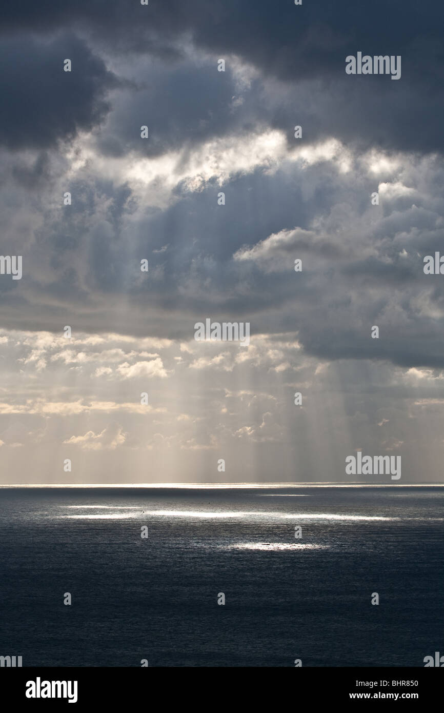 Sunbeams break through cloud above the sea Stock Photo - Alamy