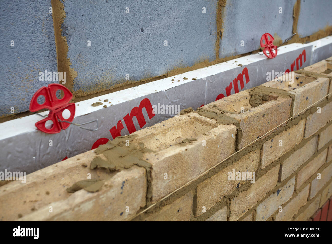 Brick wall in progress thermolite block Stock Photo - Alamy