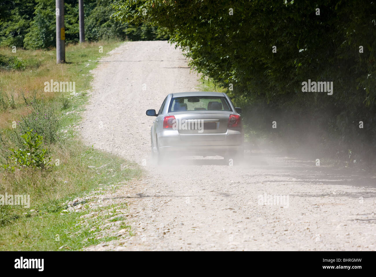Silver car at high speed on a country-side road without pavement Stock ...