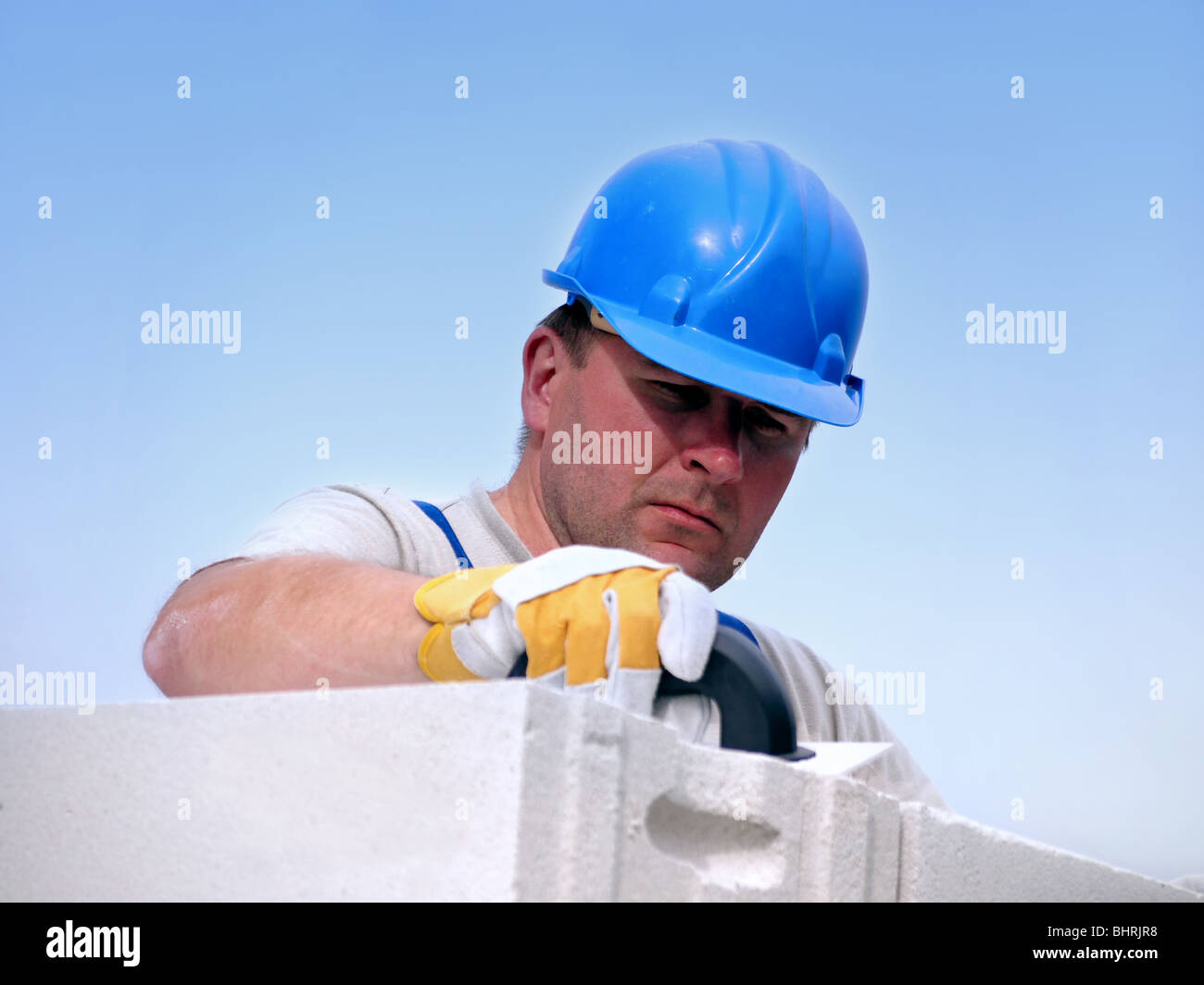 Mason applying mortar using trowel onto house wall brick layer Stock ...