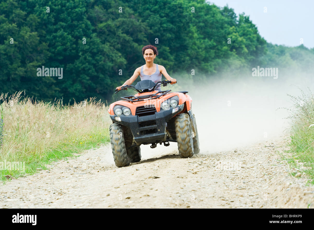 Woman riding an All Terrain Vehicle (ATV Stock Photo - Alamy