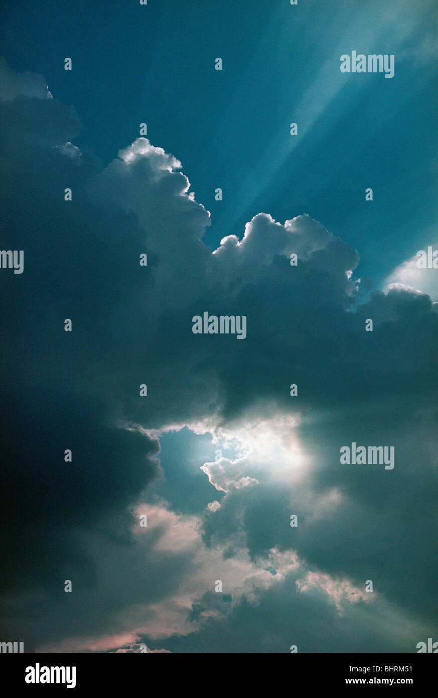 Sunshine breaking through clouds Stock Photo - Alamy