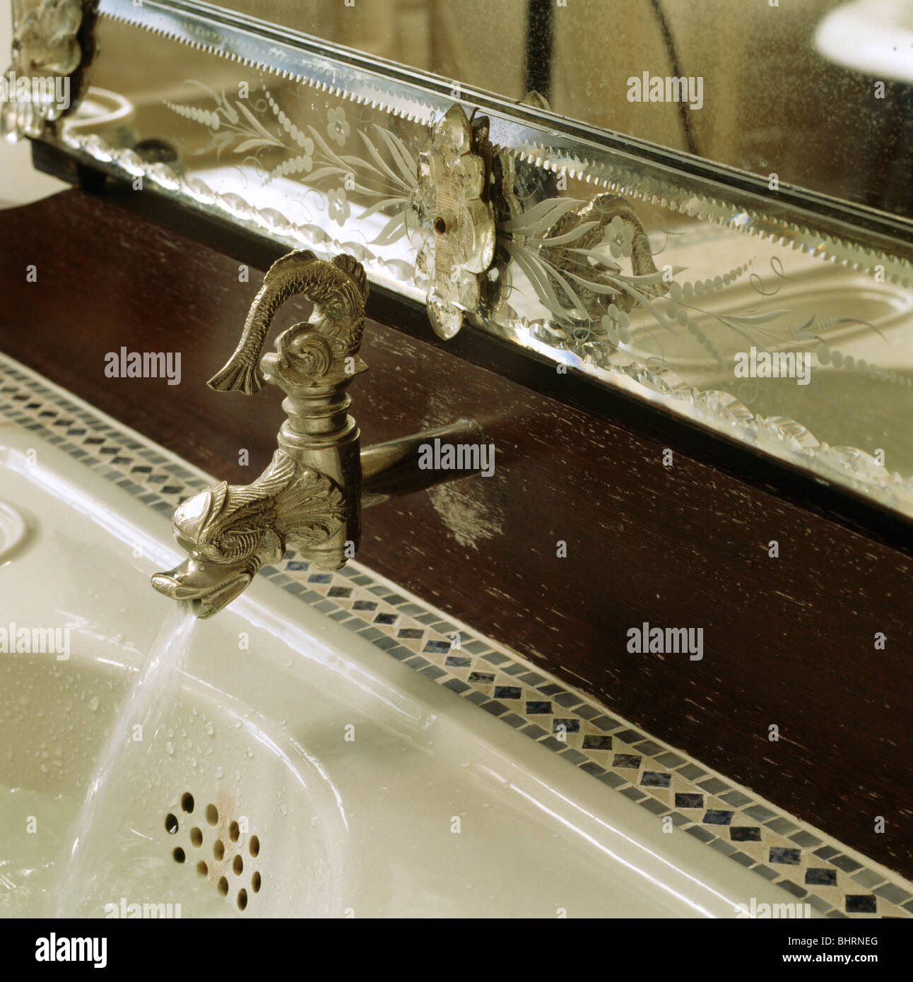 Close-up of Venetian mirror and ornate tap above basin Stock Photo - Alamy