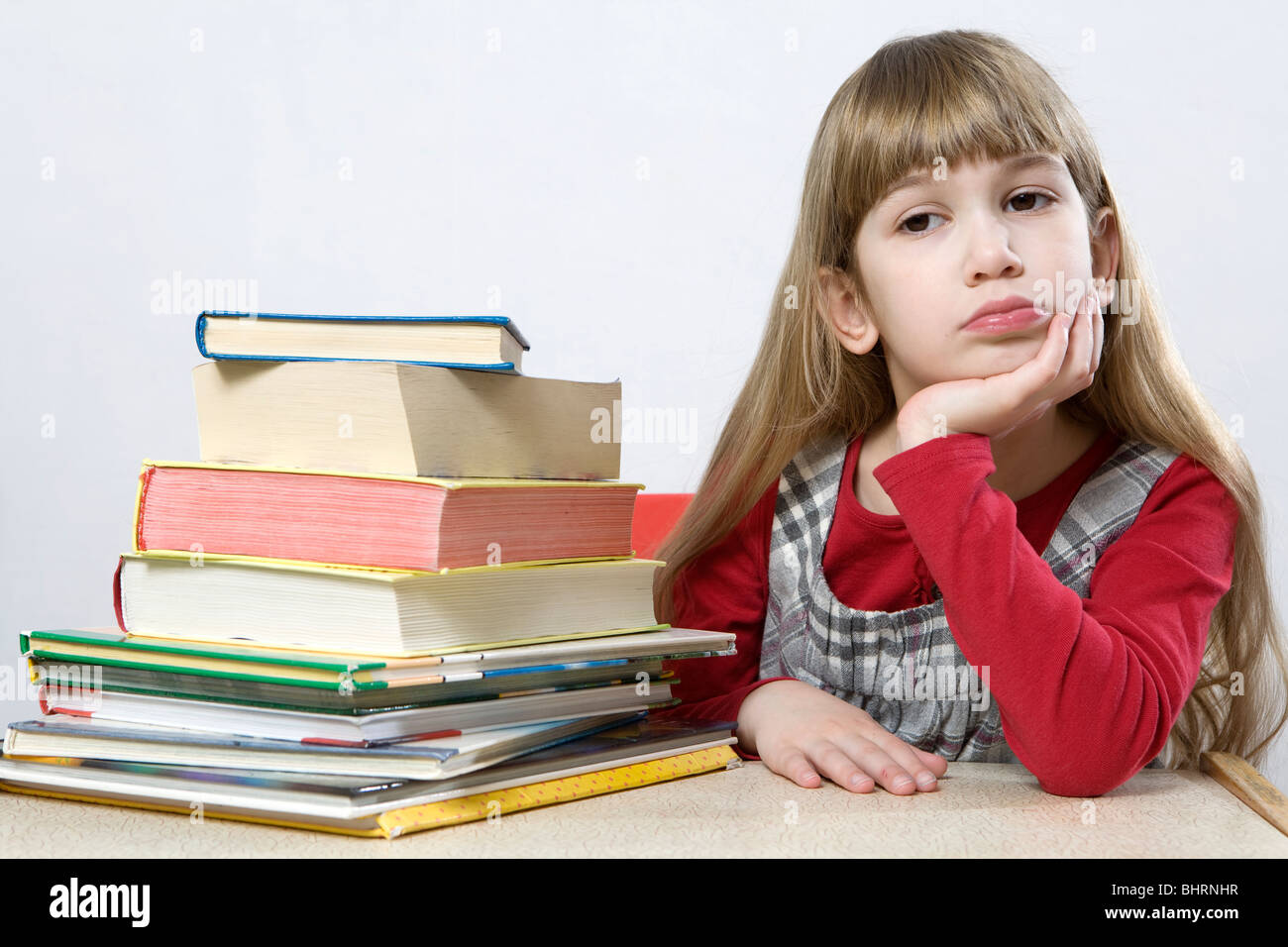 Is it possible to read all these books? little cute sad girl with a ...