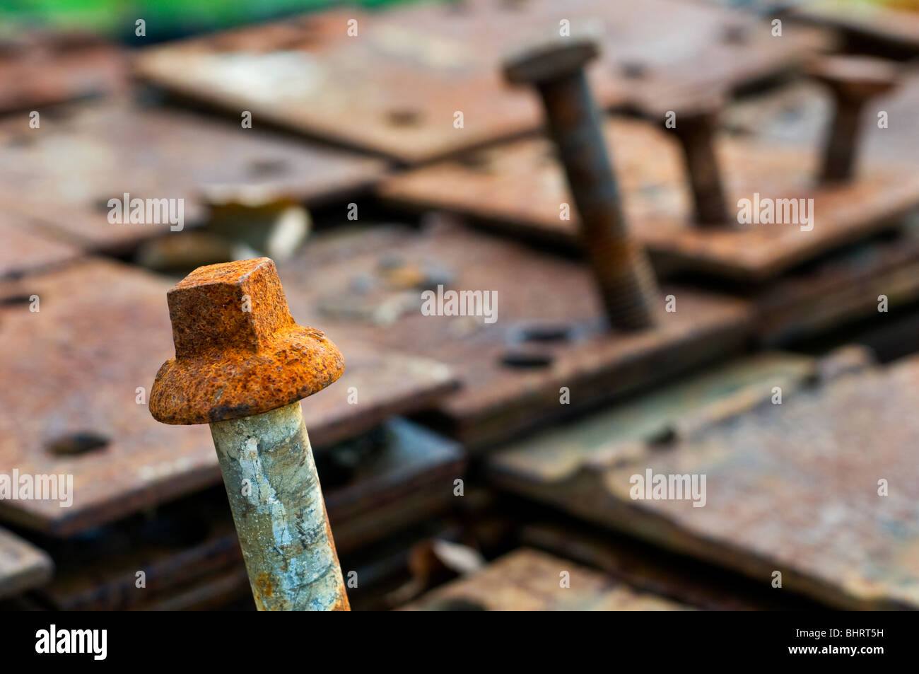 Rusty bolts on a pile of rusting metal plates Stock Photo - Alamy