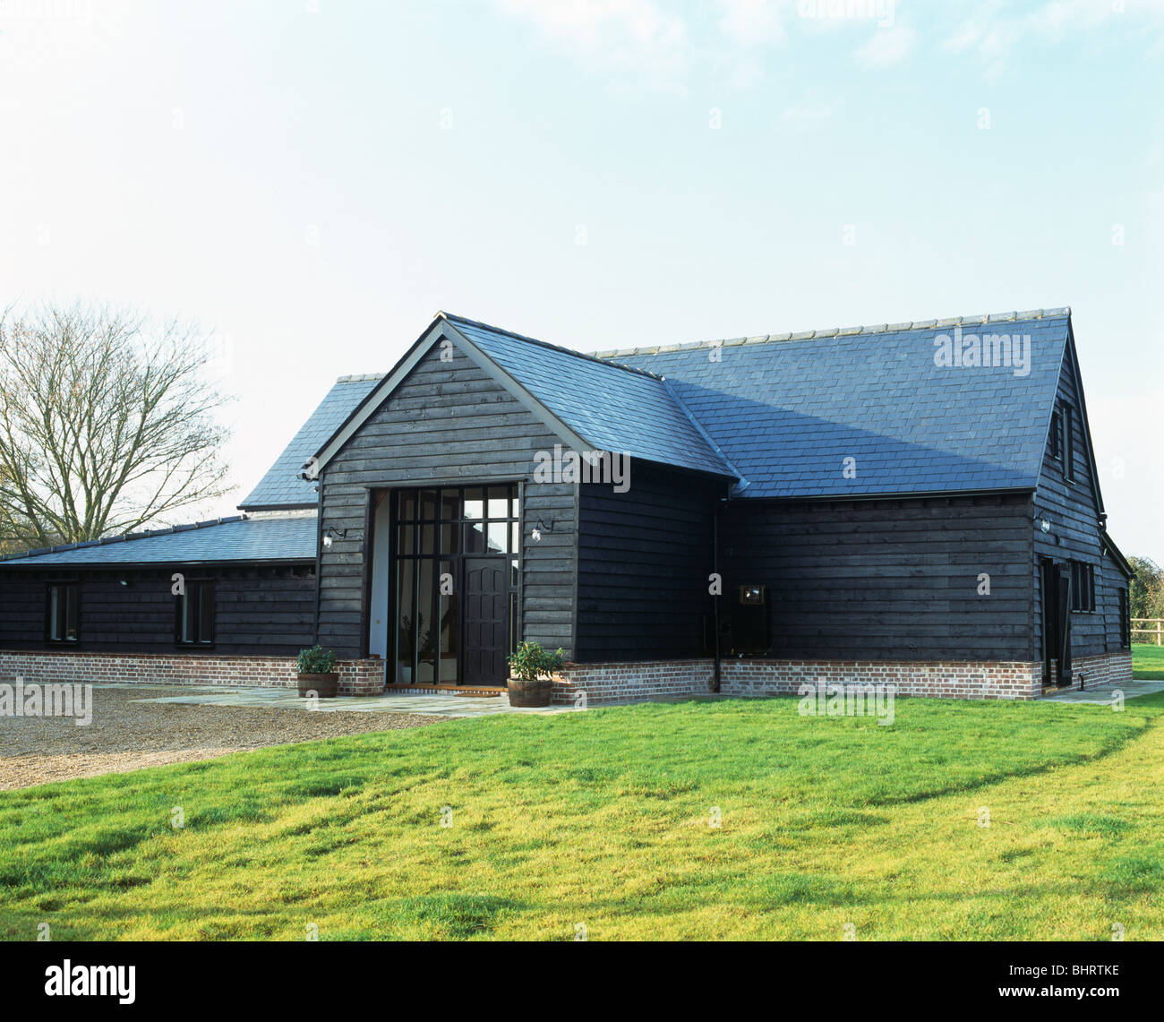 Traditional black converted barn in the country Stock Photo - Alamy
