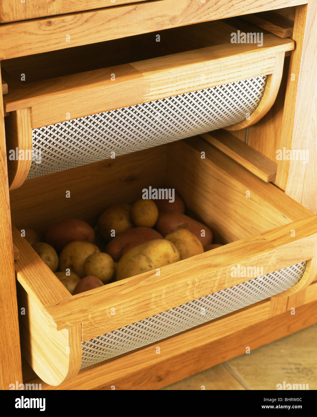 Close-up of vegetable storage drawers with potatoes Stock Photo - Alamy