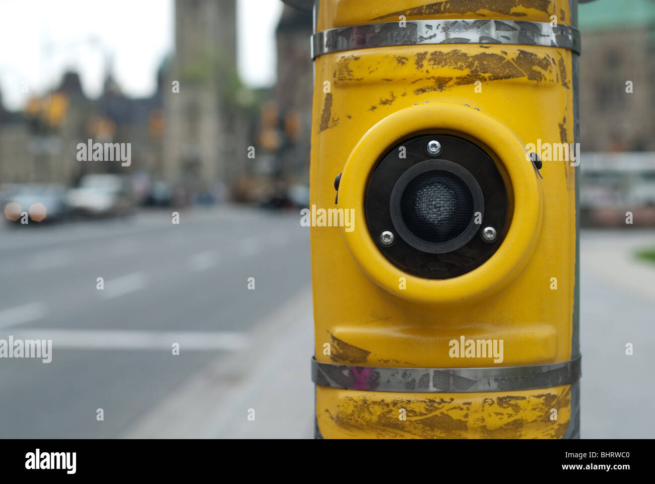 Well used pedestrian crosswalk signal button in an urban landscape ...