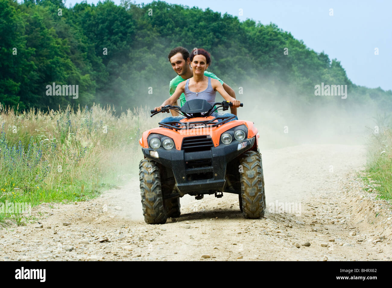 Woman riding an All Terrain Vehicle (ATV Stock Photo - Alamy