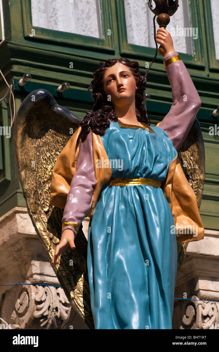 A painted papier-mâché angel positioned for the feast of Saint Mary the ...