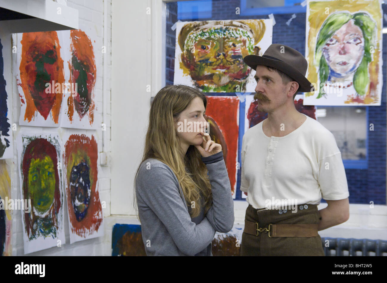 Billy Childish artist, discussing a students work with lecturer Stock ...