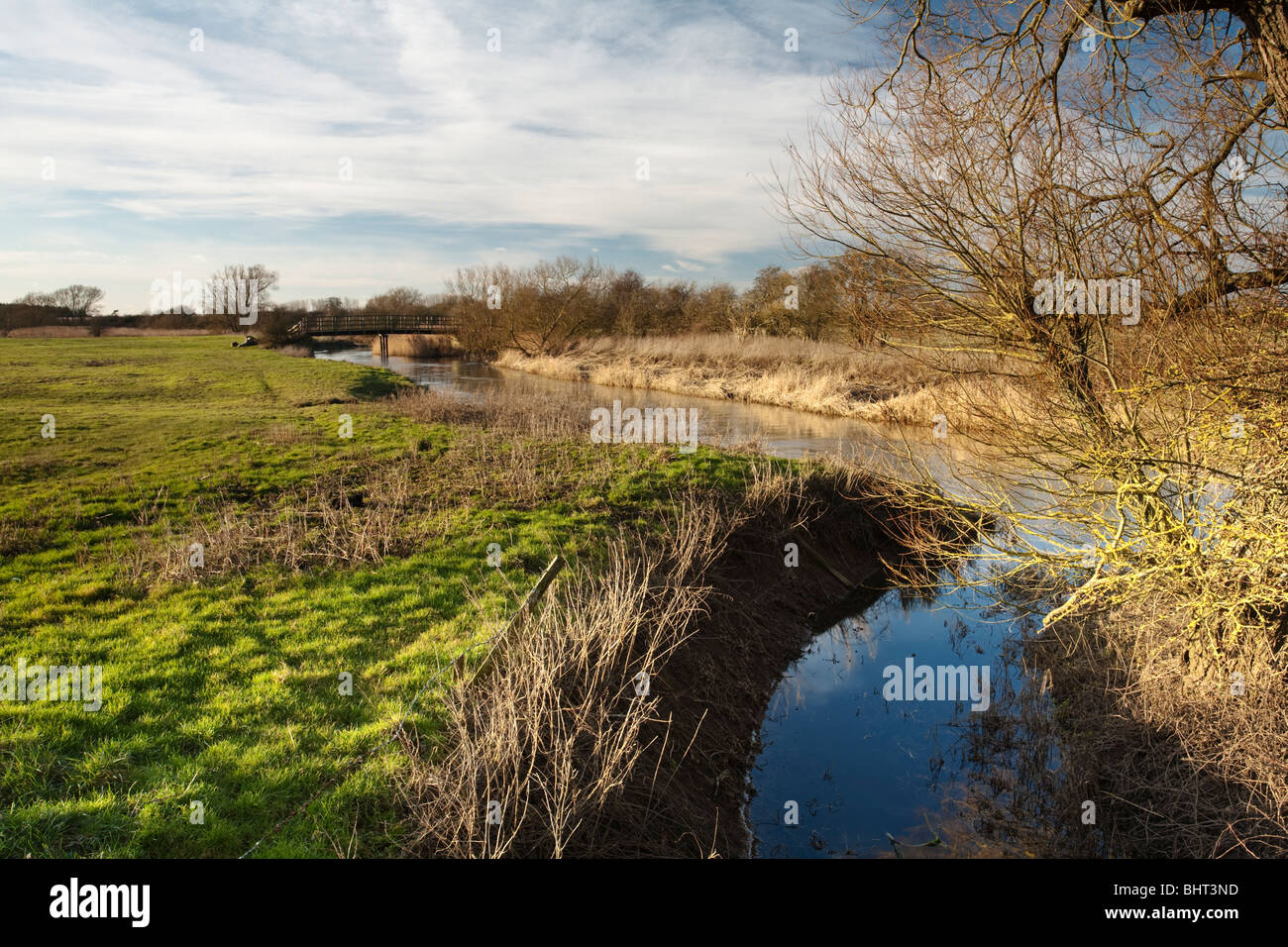 Wooden footbridge over the upper reaches of the River Thames near ...