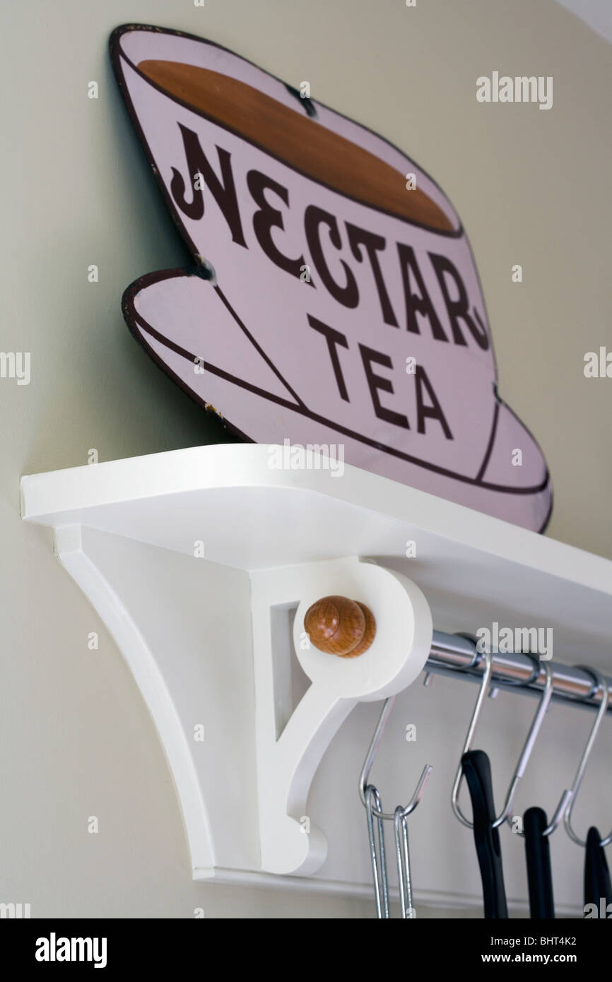 Close-up of old Nectar Tea advertising sign on white kitchen shelf with ...