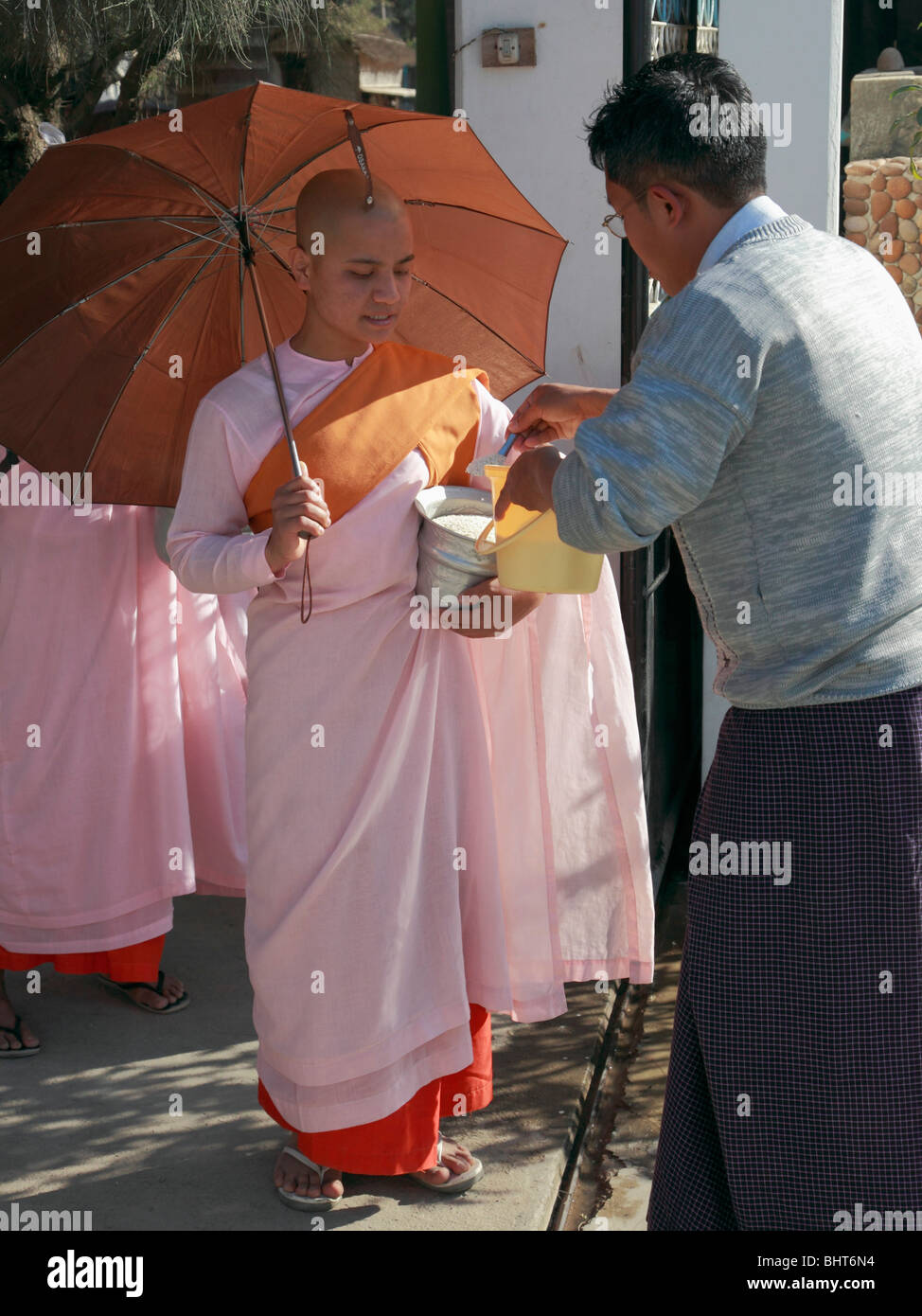 Myanmar, Burma, Nyaungshwe, buddhist nun receiving alms of rice, Shan ...