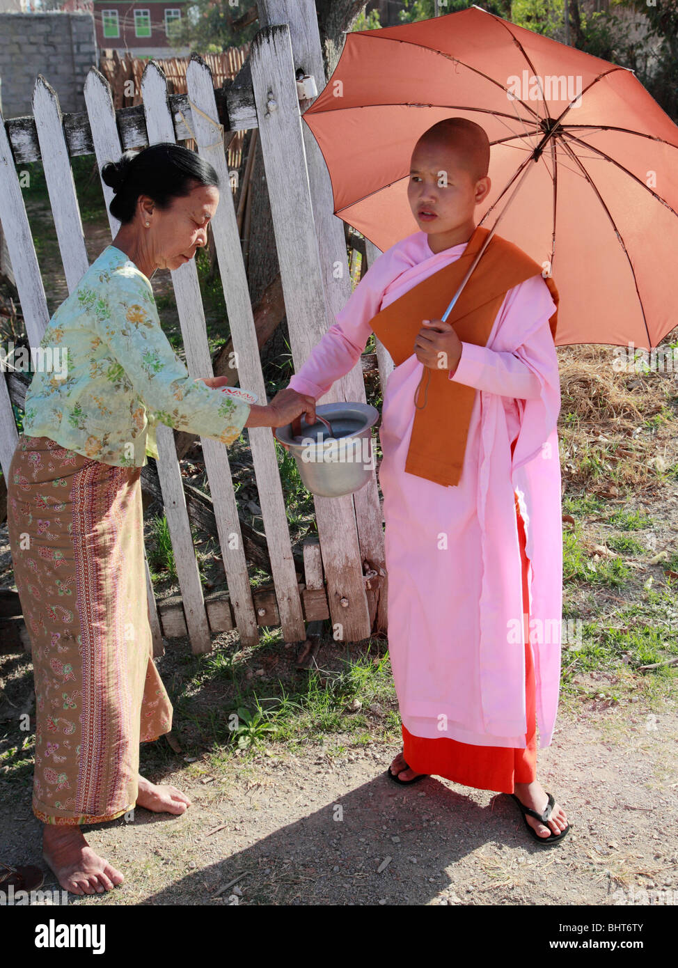 Myanmar, Burma, Nyaungshwe, buddhist nun receiving alms of rice, Shan ...