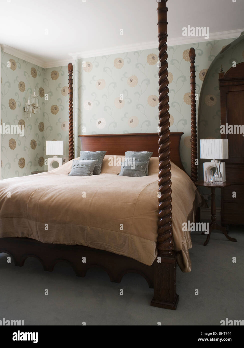 Beige bed-cover on bed with spindle posts in modern bedroom with ...