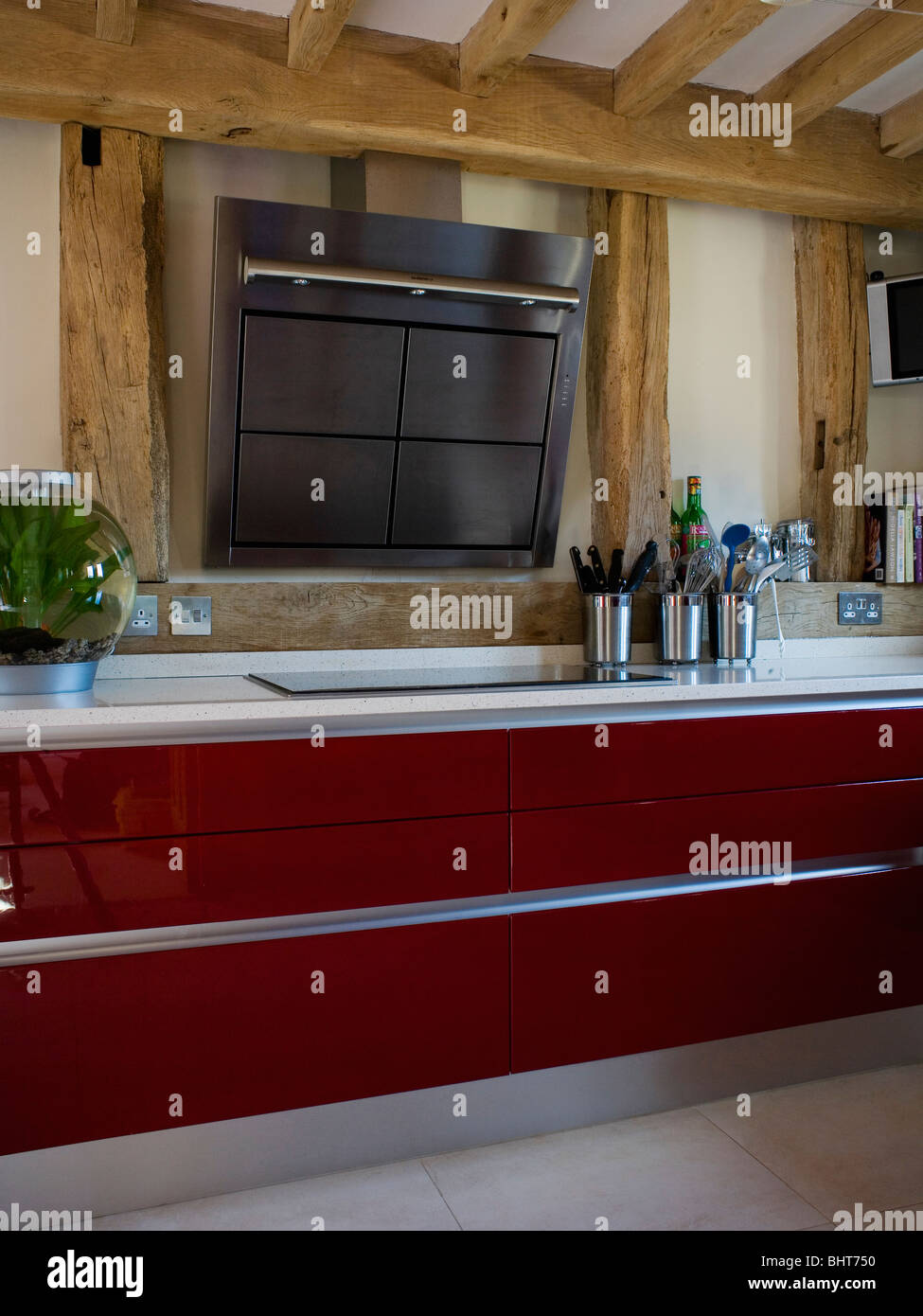 Wall-mounted black extractor above hob in modern kitchen with modern ...