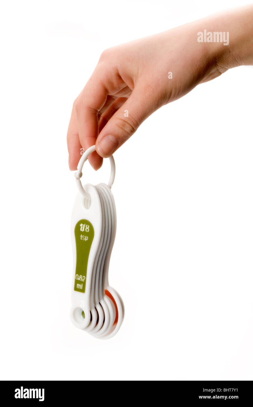 hand with measuring spoons Stock Photo - Alamy