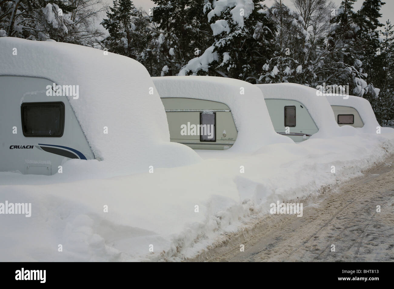 Snow Covered Caravans A line of 4 four caravans covered in snow Stock ...