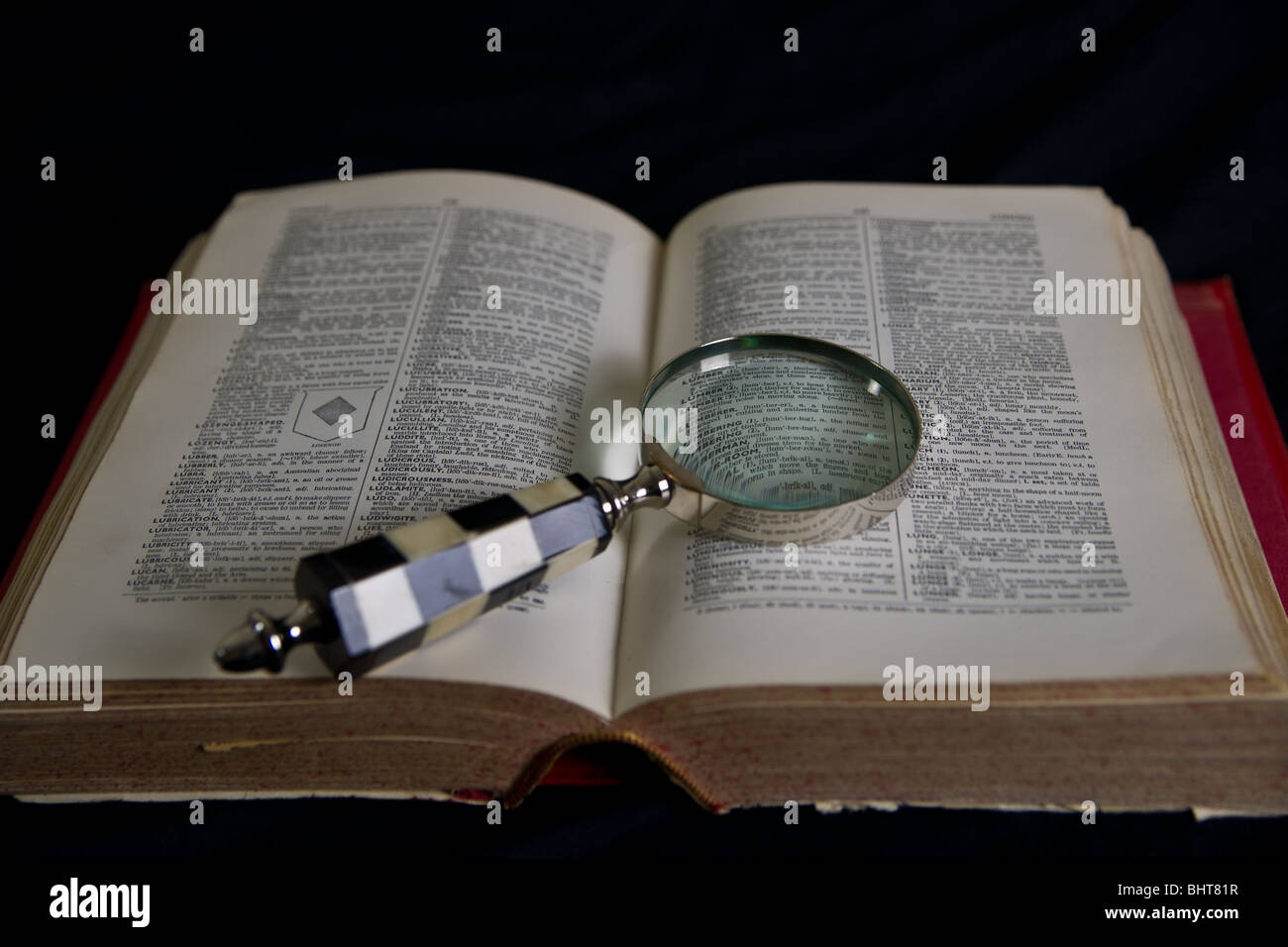 Book and magnifying glass Stock Photo - Alamy