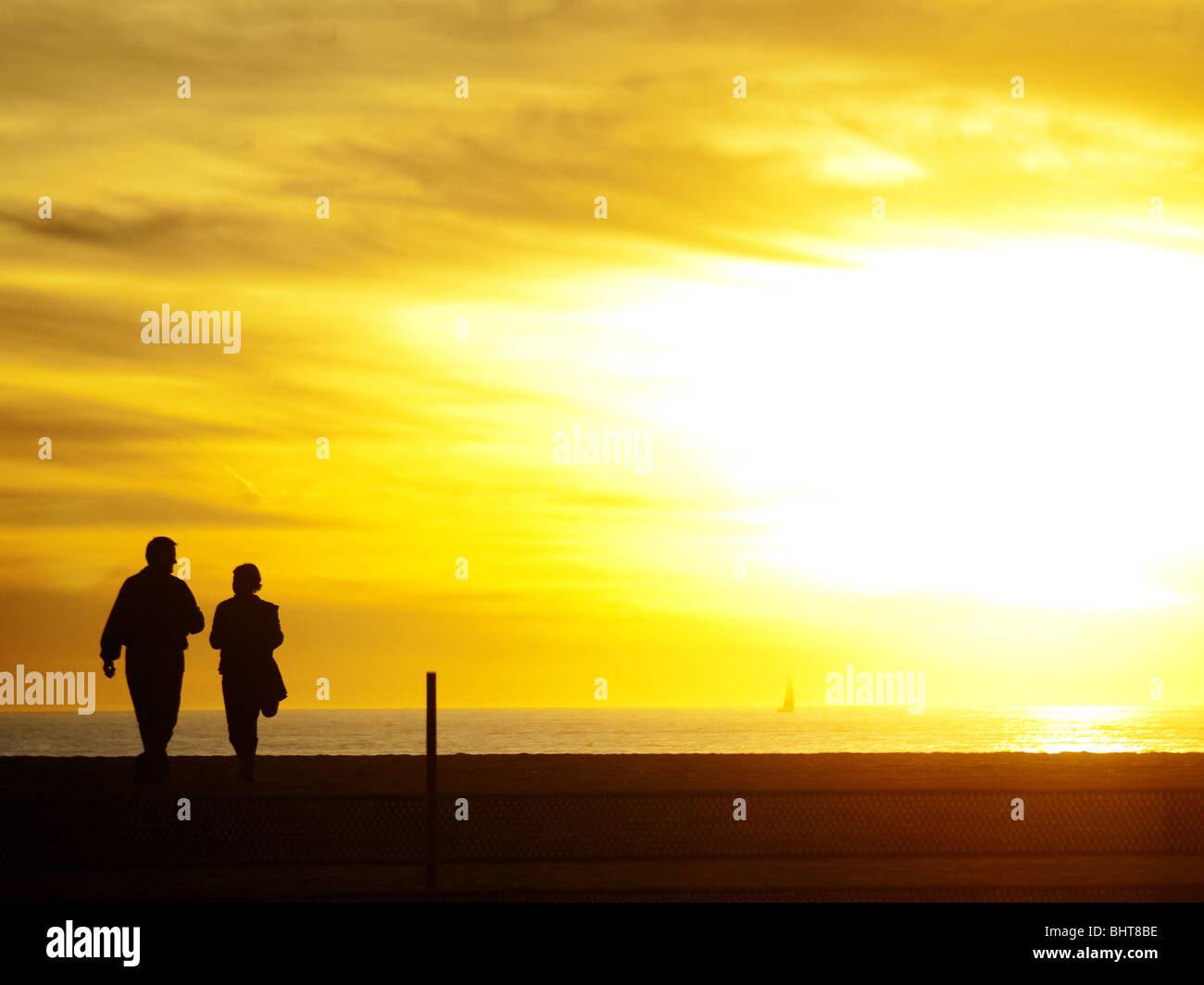 Couple at sunset Stock Photo - Alamy