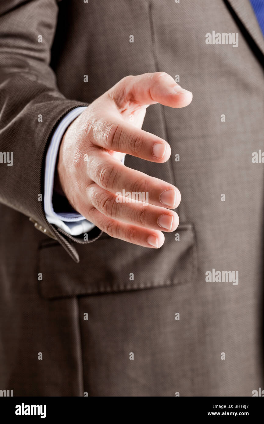 Successful business man giving a handshake Stock Photo - Alamy