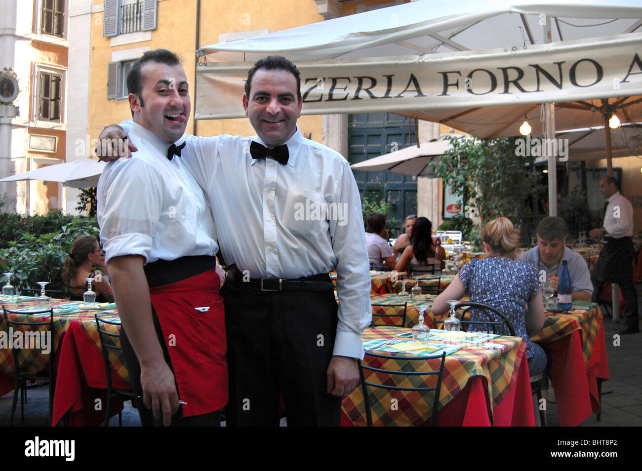 Smiling waiters posing outside restaurant in Rome city centre Stock ...