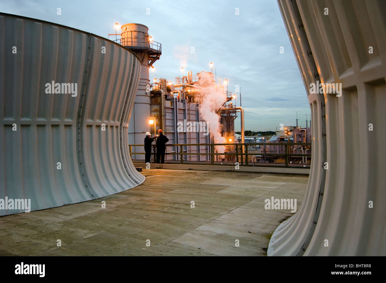 natural gas fired power plant cooling towers in evening light with two ...