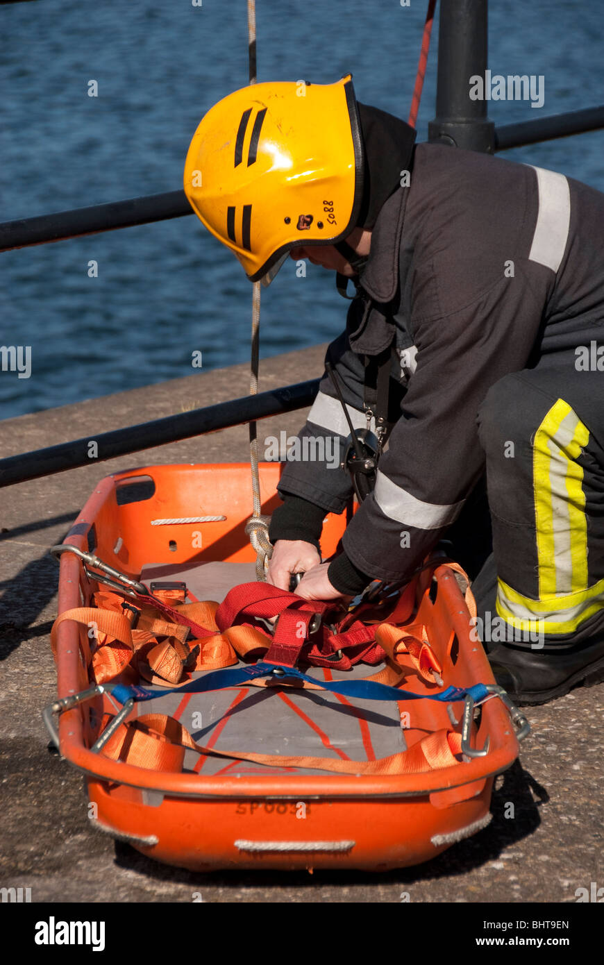 Fireman preparing basket stretcher for rescue Stock Photo - Alamy